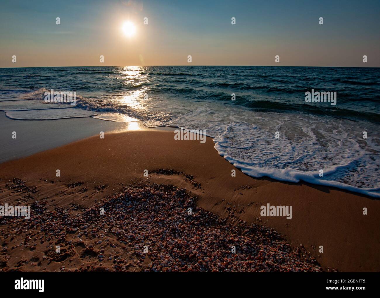 Stunning sunset scenery over the sandy beach Stock Photo - Alamy