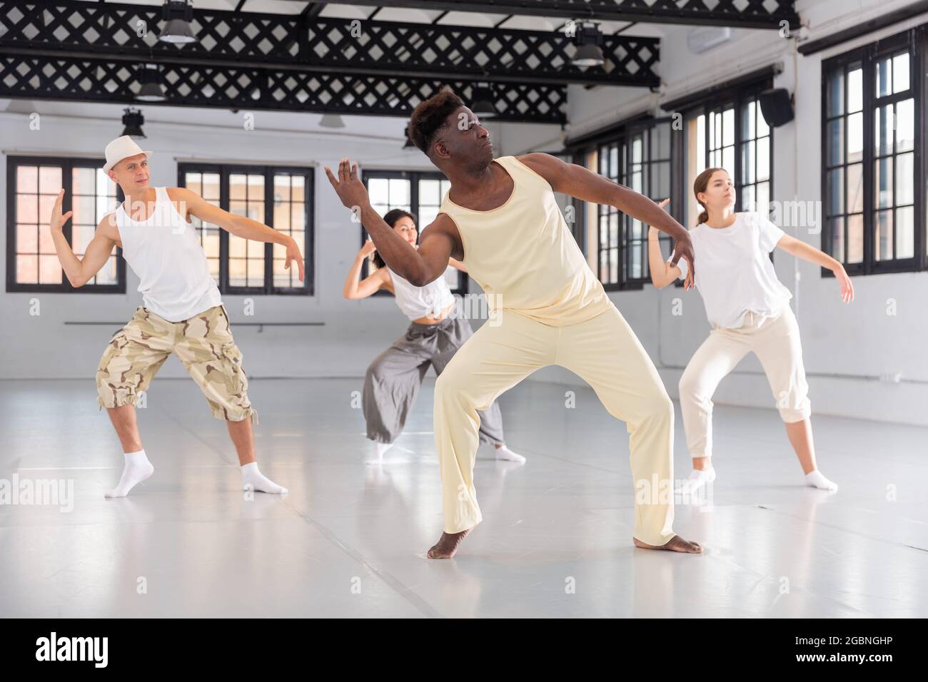 Four dancers exercising contemporary dance movements Stock Photo - Alamy