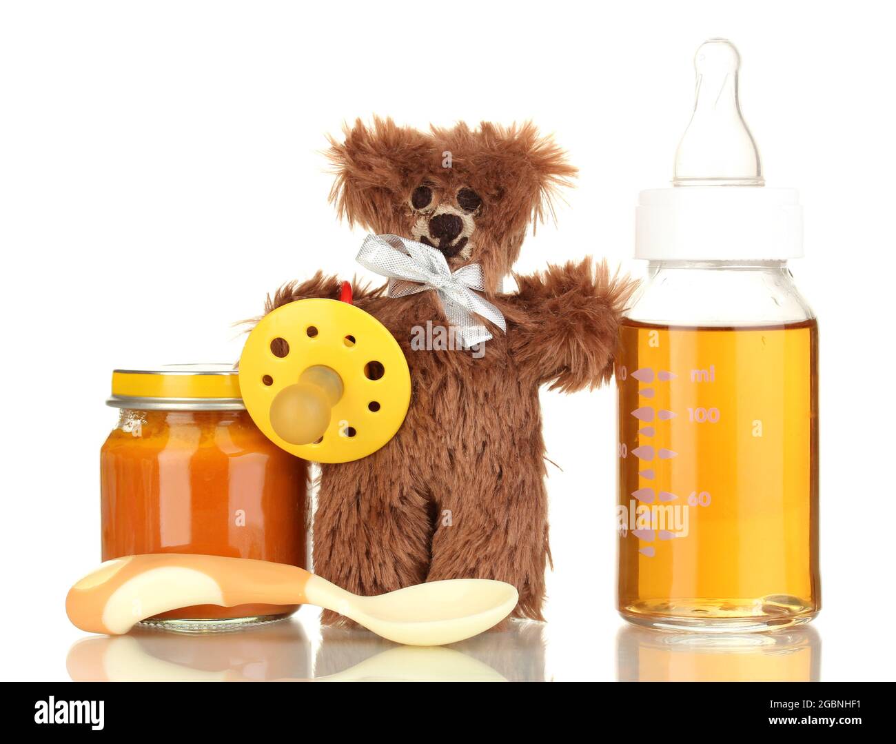 Baby bottle with fresh juice, puree and teddy bear isolated on white ...