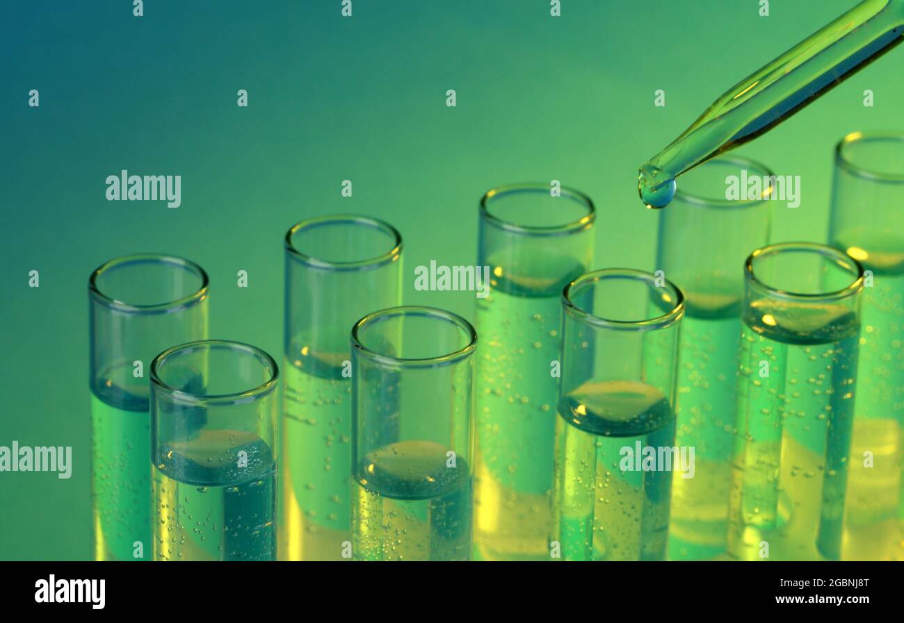 test-tubes with liquid on blue background Stock Photo - Alamy