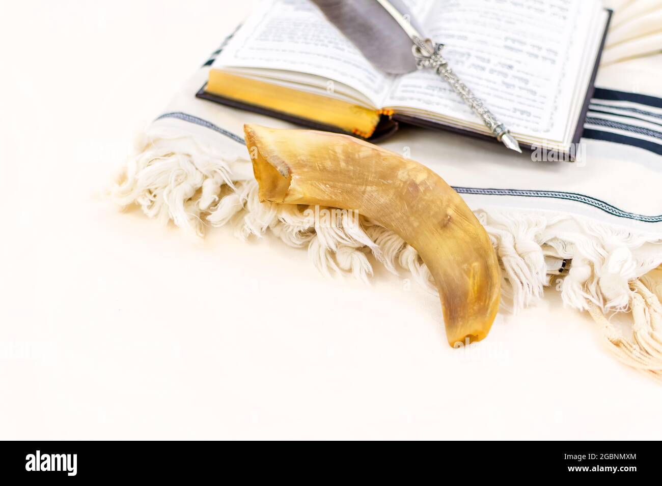 Traditional Jewish shofar horn with a siddur prayer book and a feather ...