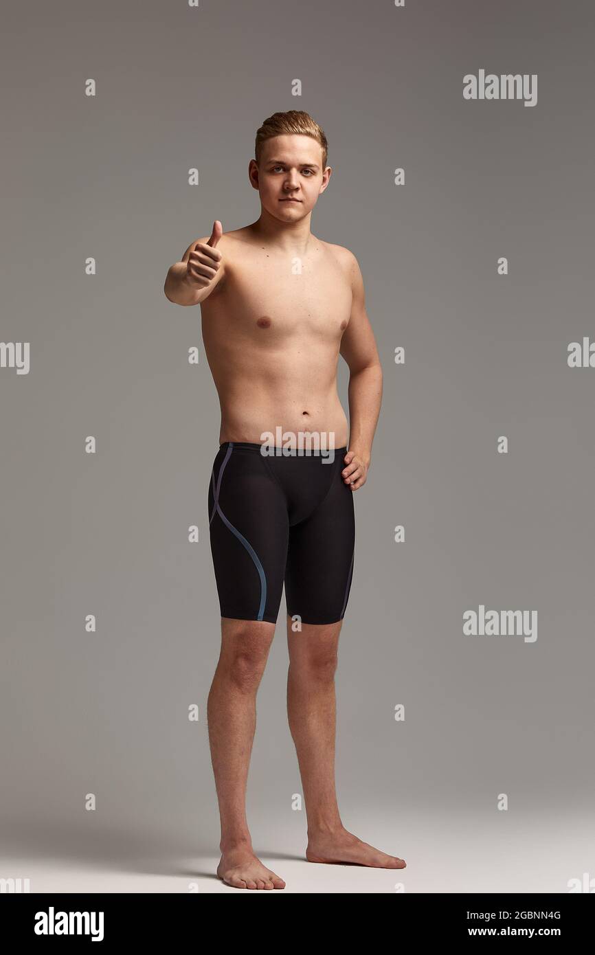 Handsome fit man holding thumbs up, showing great shape, sportsman ...