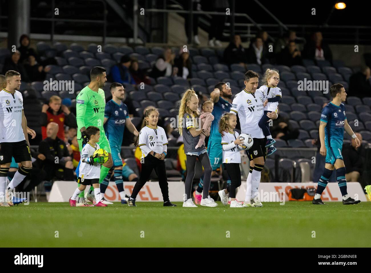 Mark Milligan of Macarthur FC enters the field with his daughters ...