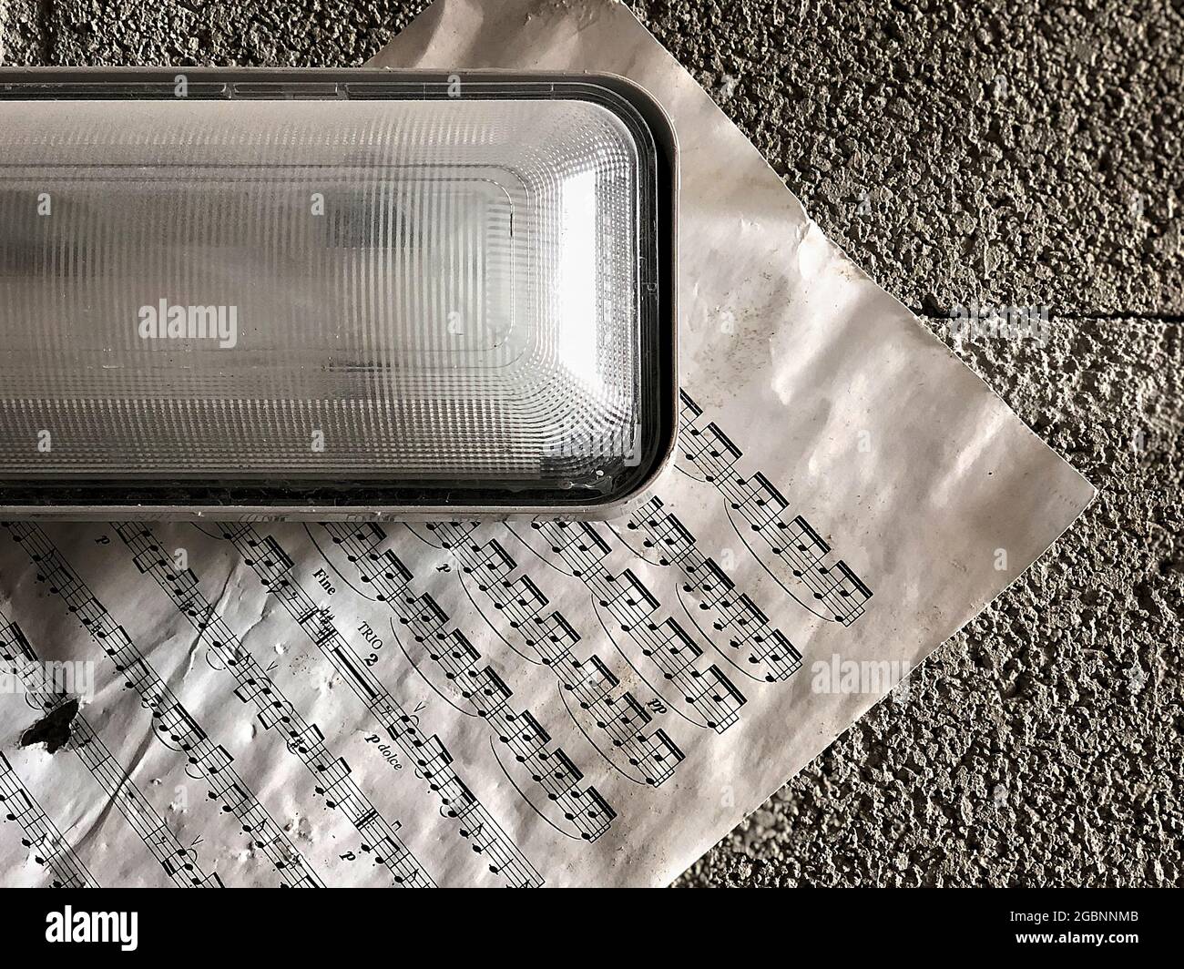Top view closeup of a lamp and score on a concrete brick wall. Still ...