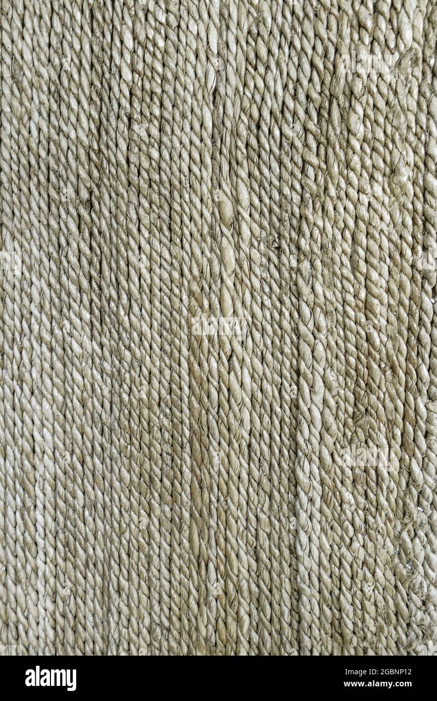 Vertical shot of an abstract pattern of a beige thick thread covered ...