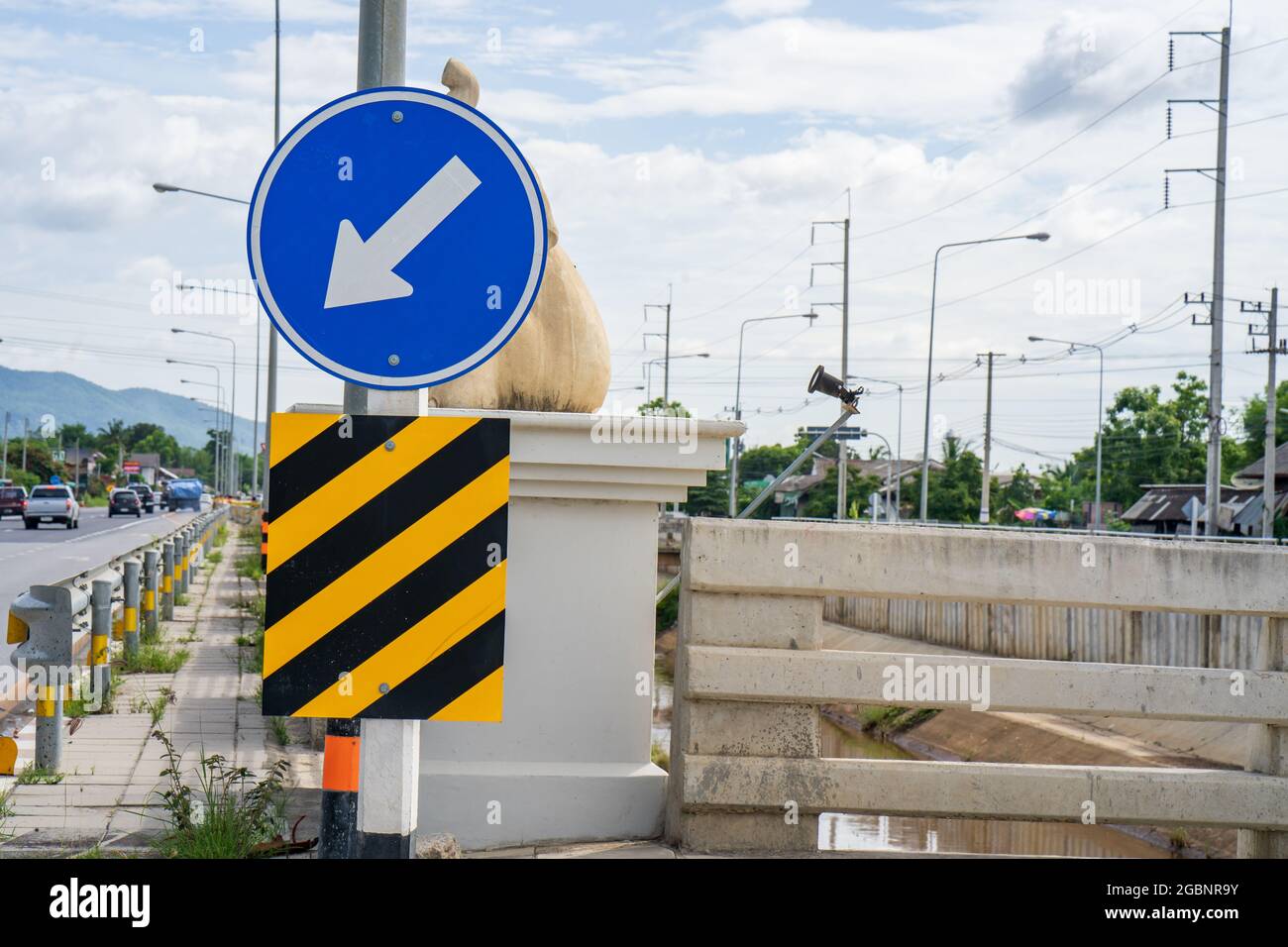Blue traffic keep left sign outdoors Stock Photo - Alamy
