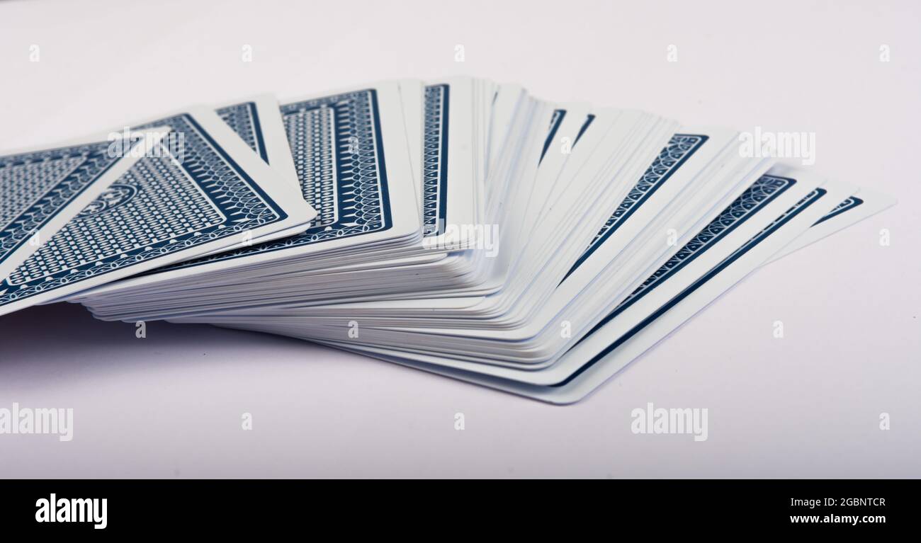 Closeup view of a deck of playing cards spread on the white table Stock ...