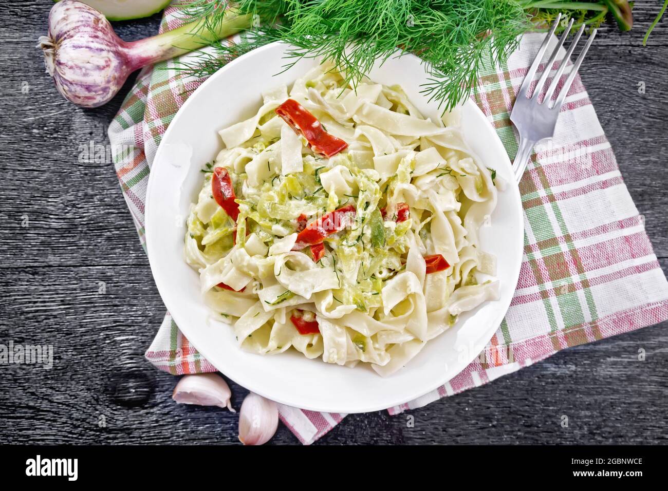 Fettuccine pasta with zucchini and hot red pepper in creamy sauce in ...