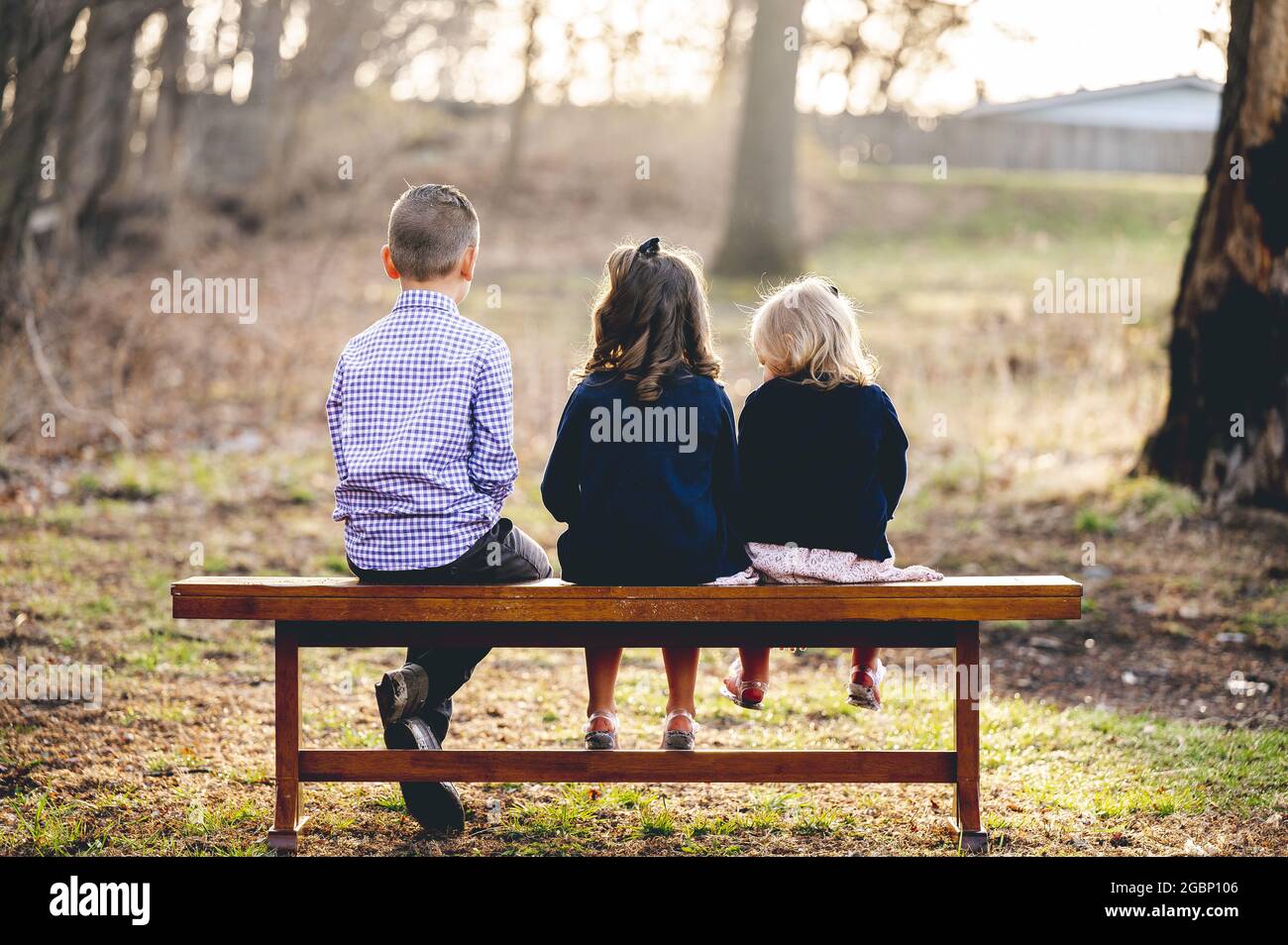 Scenic view of kids sitting on the bench outdoors Stock Photo - Alamy