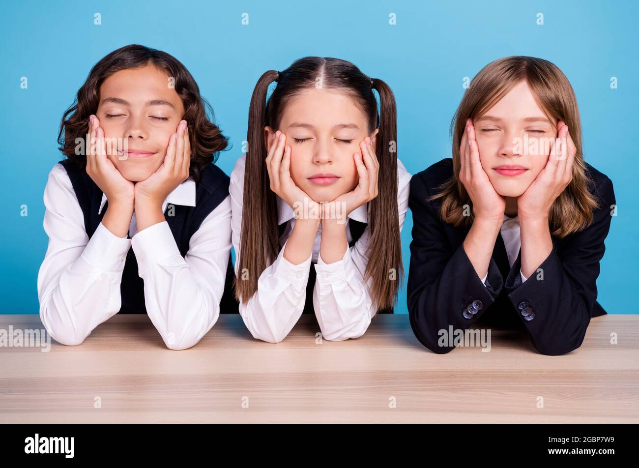 Photo of adorable dreamy schoolchildren wear uniform smiling closed ...