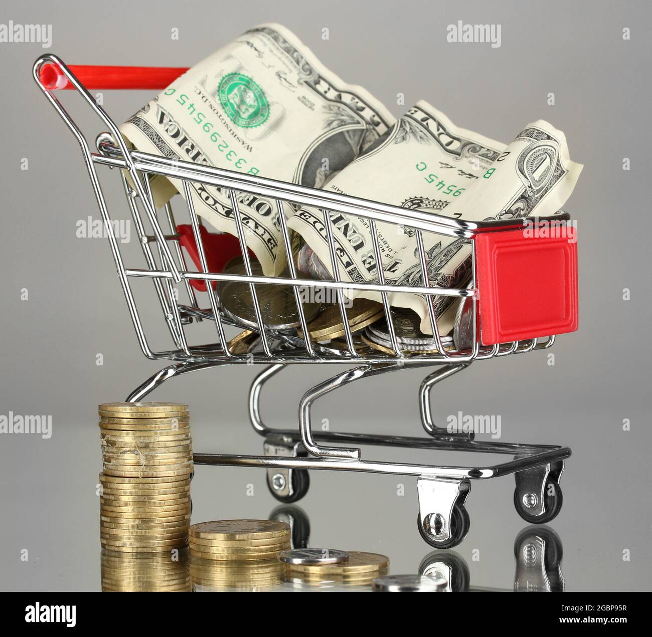 Money in cart on grey background Stock Photo - Alamy