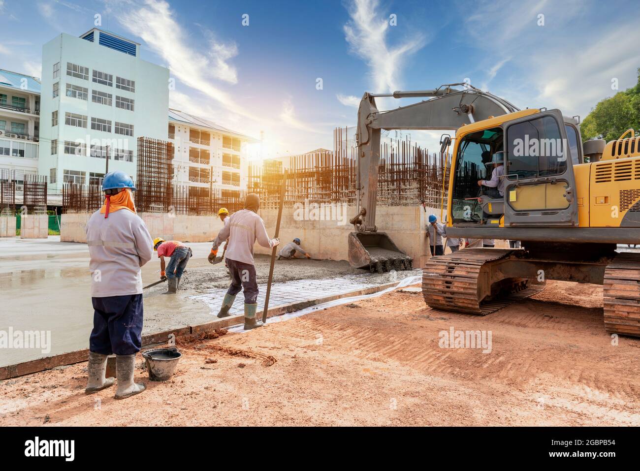 A construction worker with excavator heavy machine and cement truck for ...