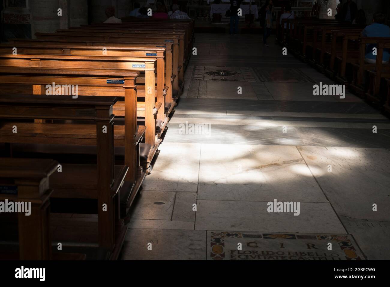 Divine, golden light streams through a window and shines on the center ...