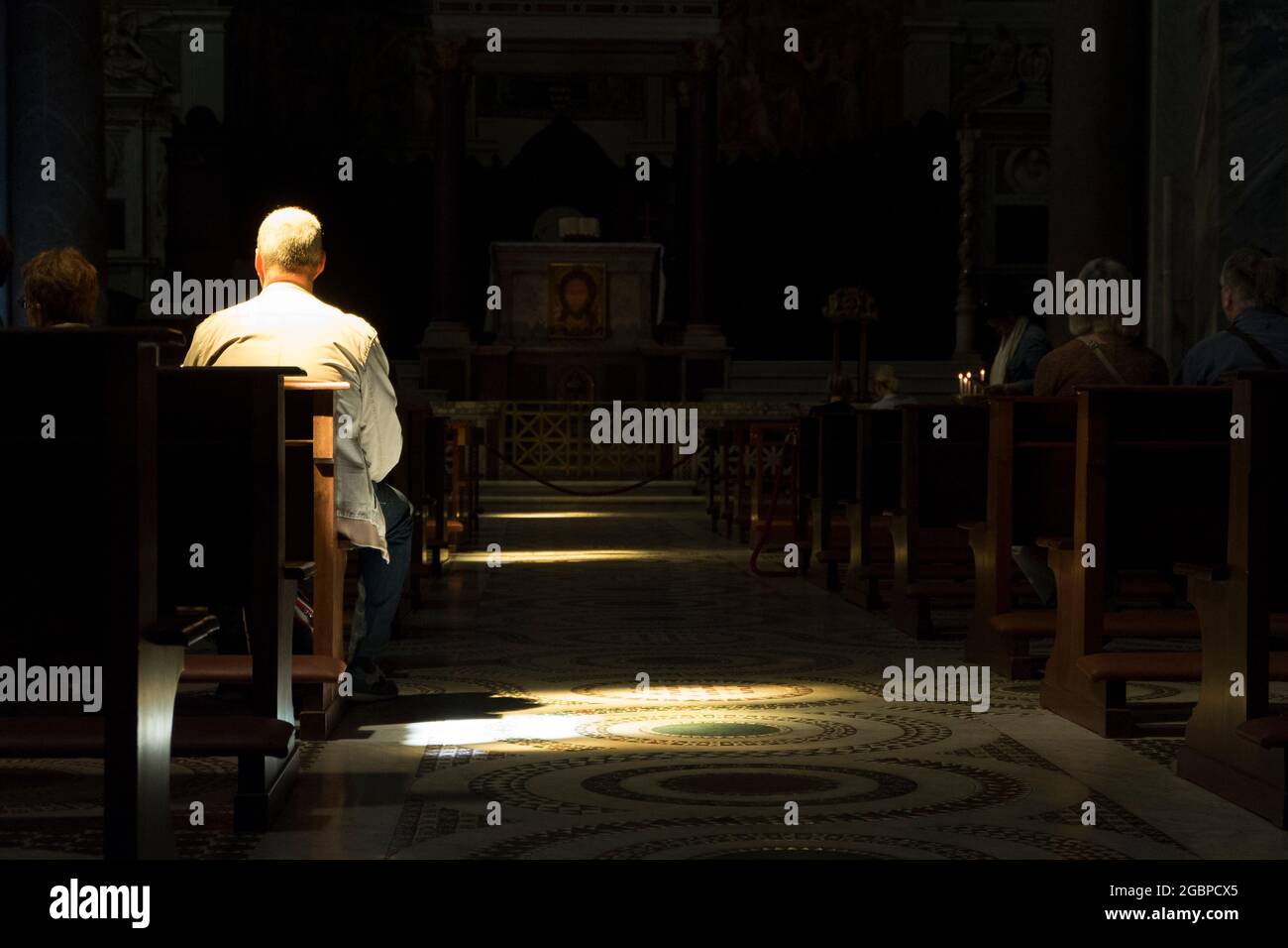 Divine, golden light streams through a window and shines on a ...