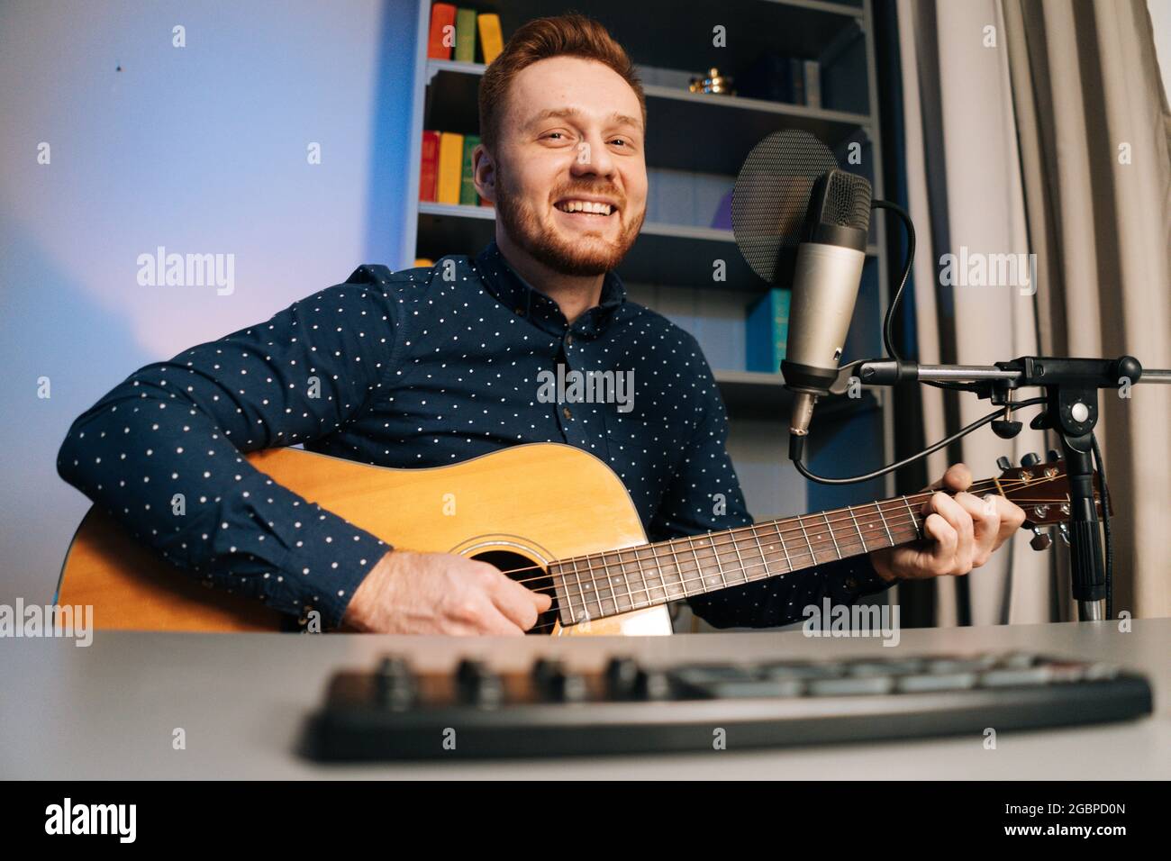 Shoot from below of laughing guitarist singer man play on acoustic ...