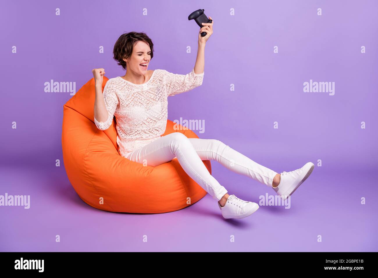 Photo of lucky pretty young lady dressed white shirt sitting bean bag ...