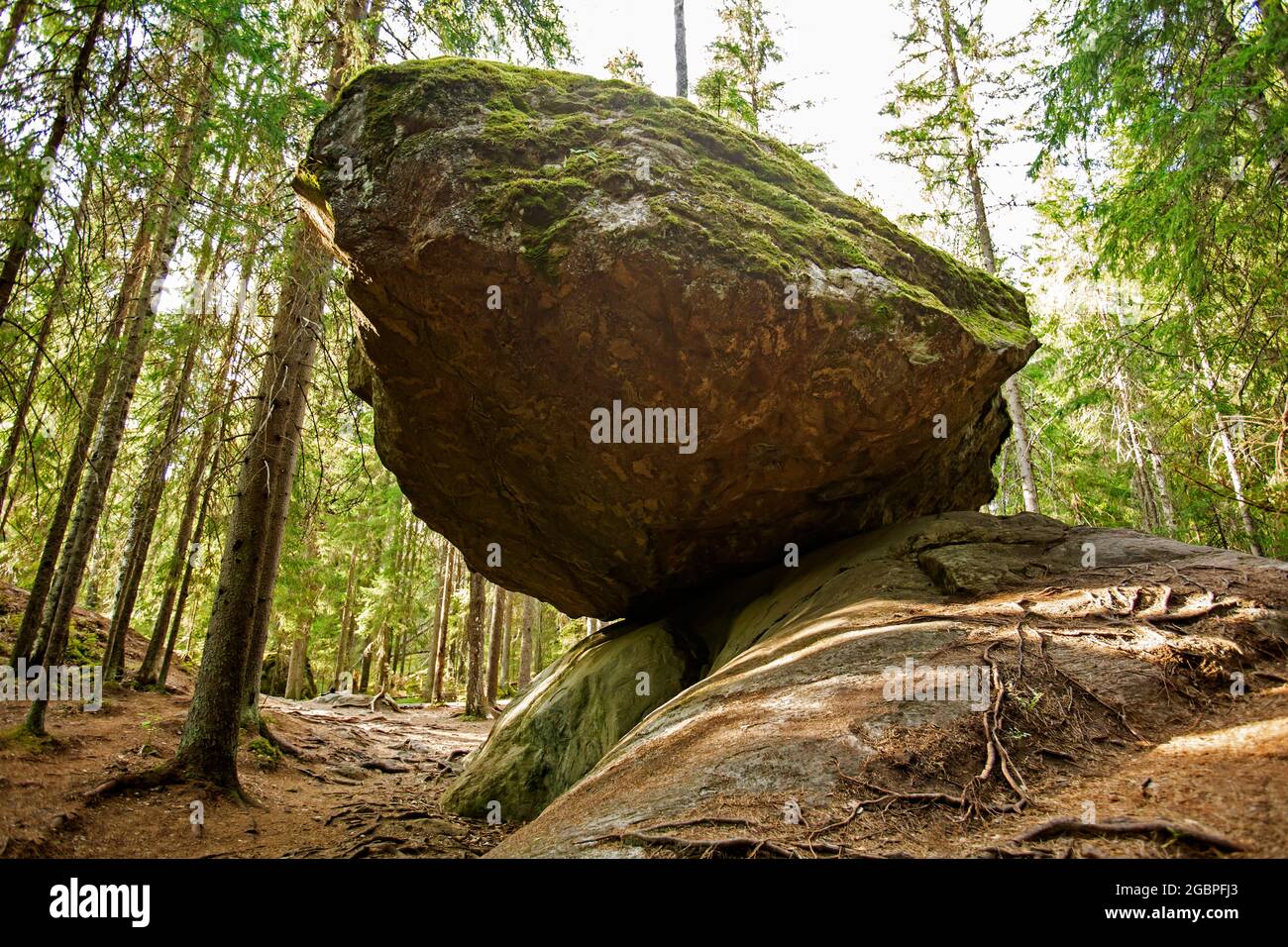 A large balancing boulder rock called Kummakivi in Finnish nature near ...