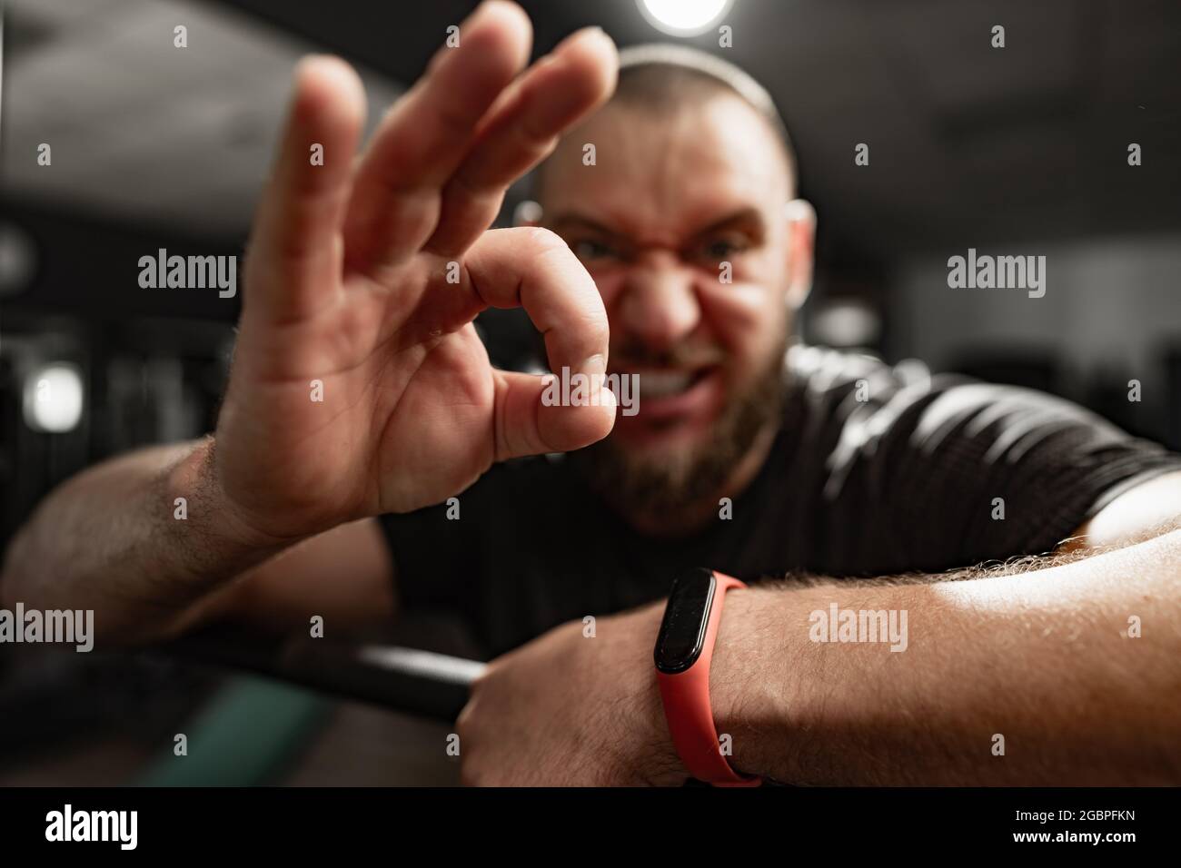Cheerful smiling man bodybuilder standing in a gym Stock Photo - Alamy