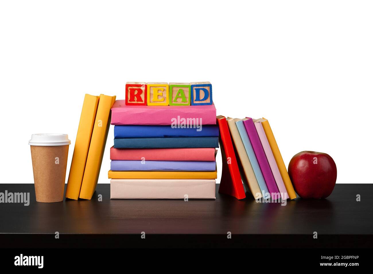 Stack of books and apple on tabletop against white background Stock ...
