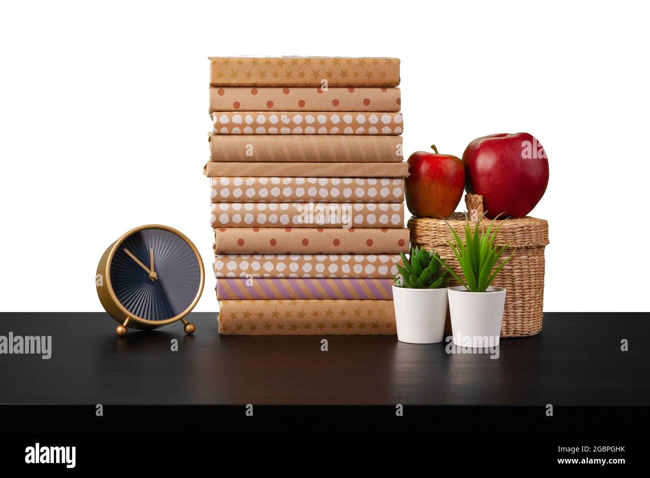 Stack of books and apple on tabletop against white background Stock ...