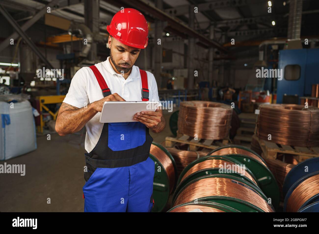 African american male manager in electric cable warehouse holding ...