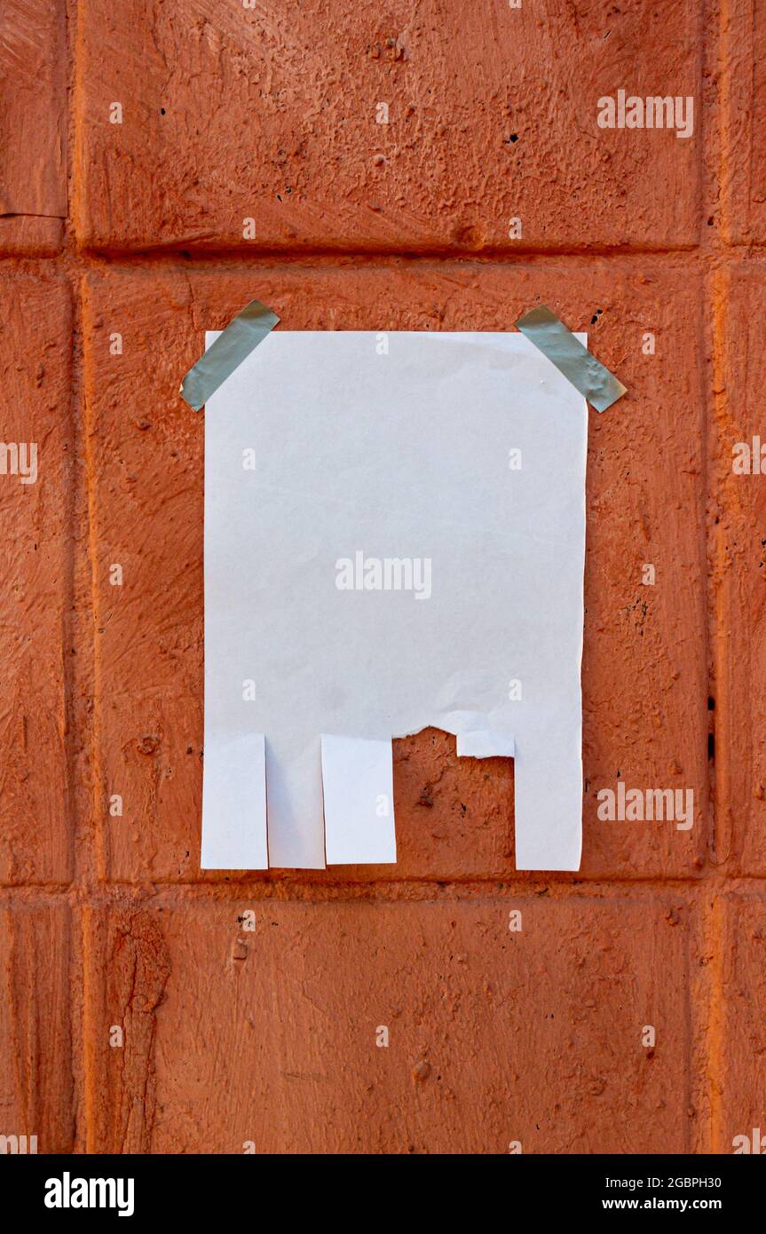 Tear off paper on paint wall. Mock up template. Street paper ad or ...