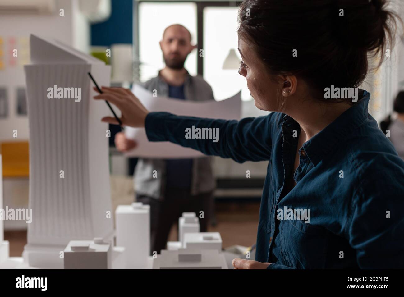 Architecture office partners looking at blueprints and plans for ...
