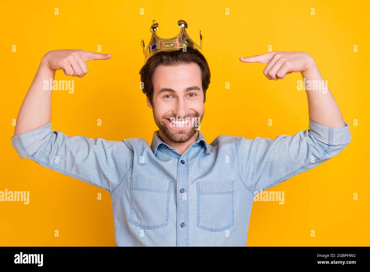 Photo of young cheerful man happy positive smile show fingers crown ...