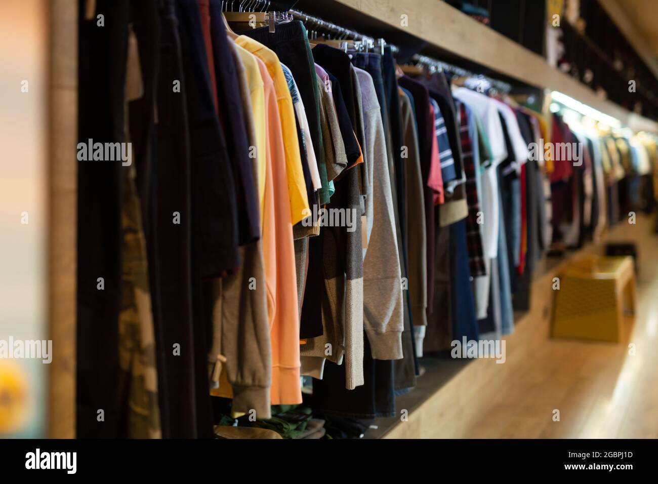 Stand with various clothes in clothing boutique Stock Photo - Alamy