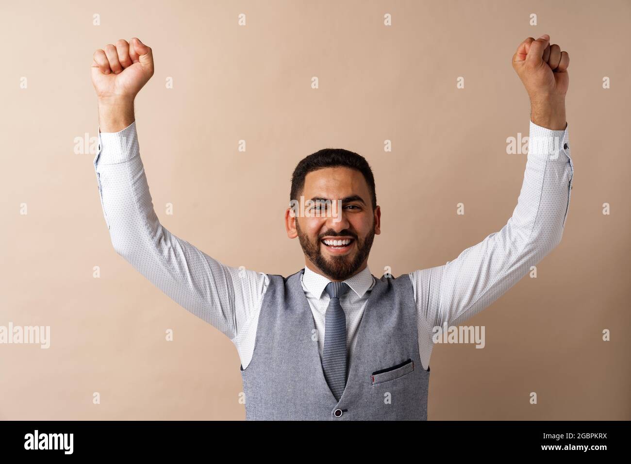 Young arab successful man celebrating triumph in studio Stock Photo - Alamy