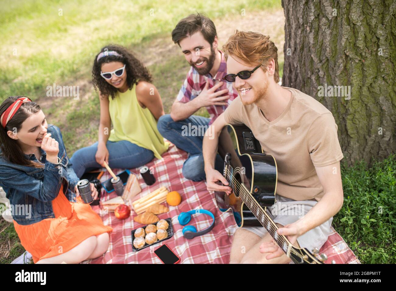 Young girls and guys spending weekend in nature Stock Photo - Alamy
