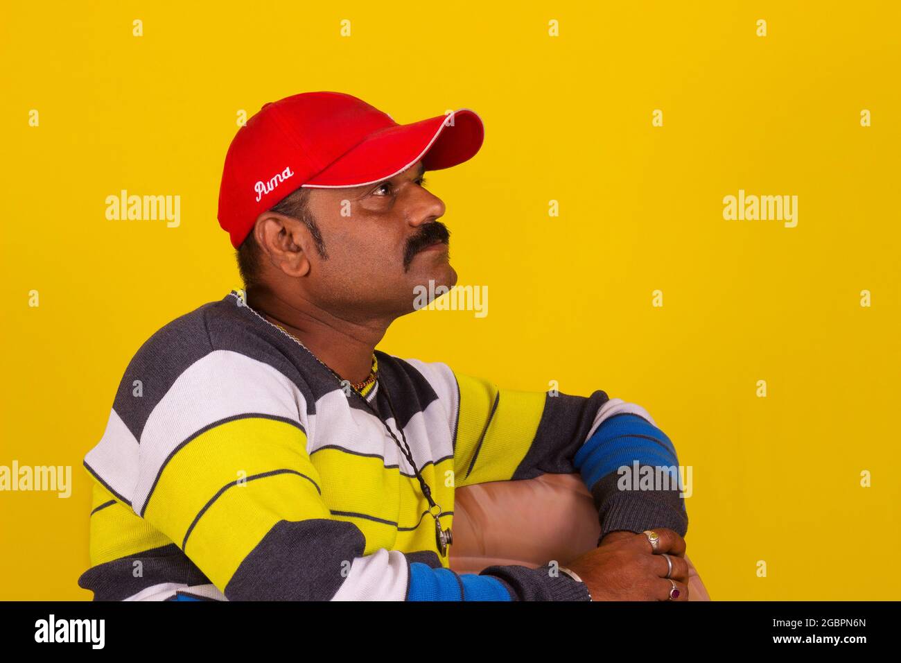 Young Indian man with red cap Stock Photo - Alamy