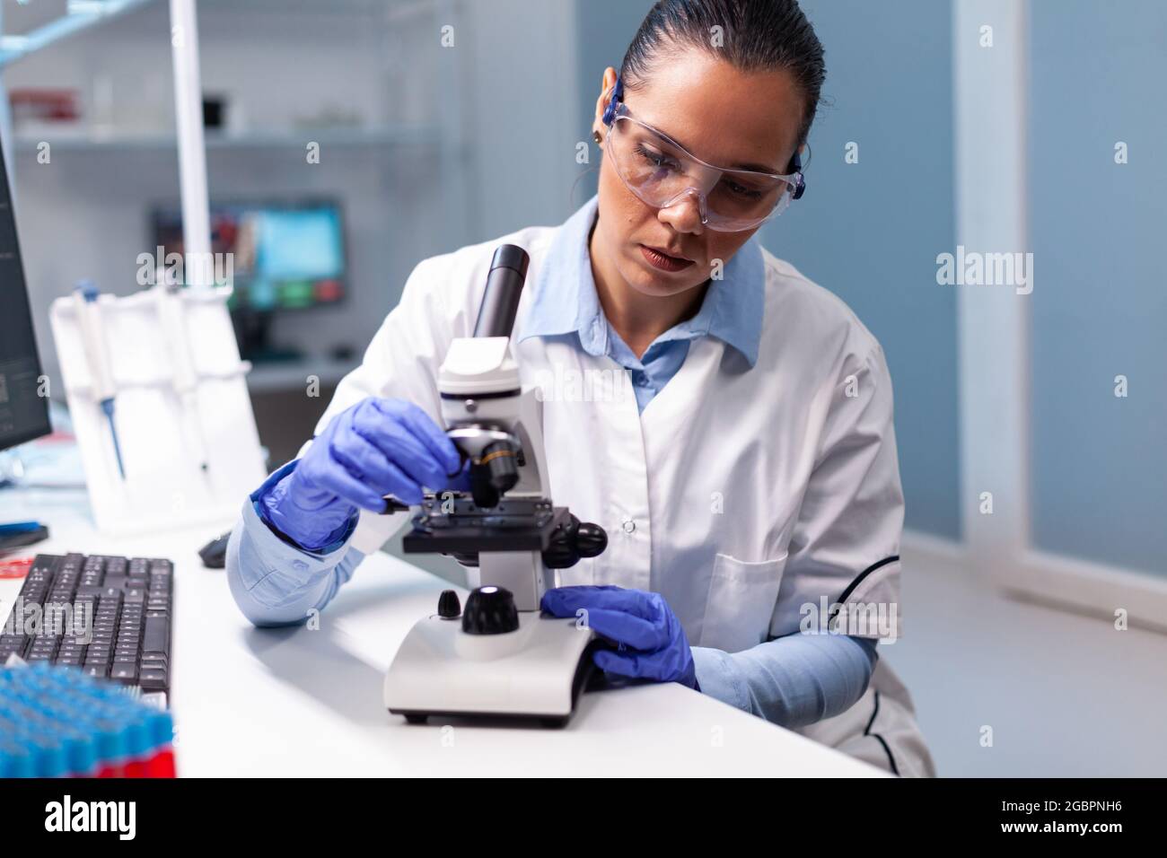 Microbiologist doctor woman analyzing vaccine results using medical ...