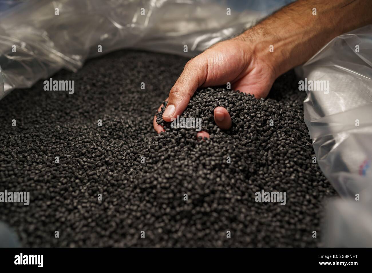 Close up of male hand holding plastic polymer granules Stock Photo - Alamy