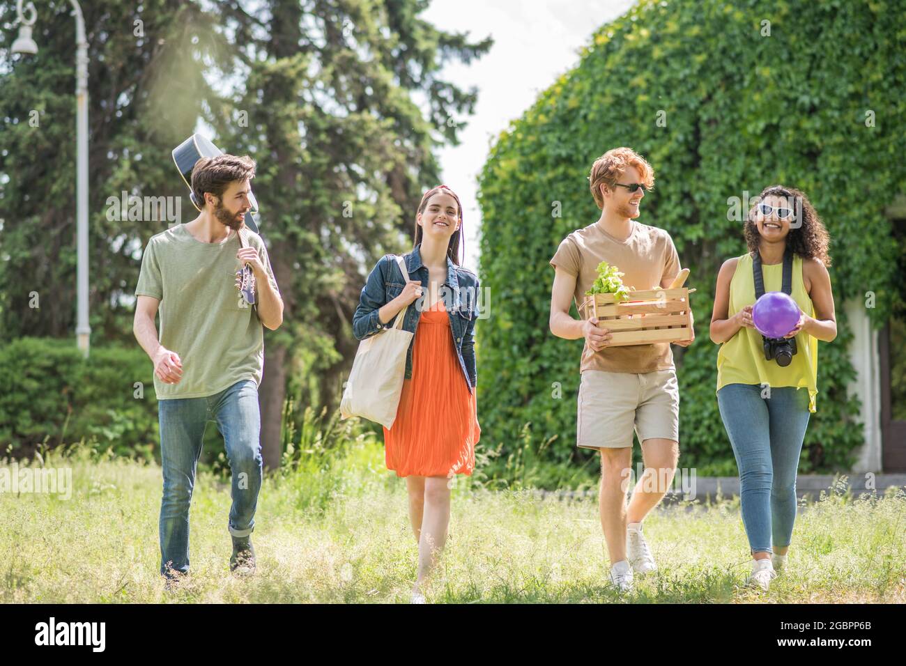 Young people walking on summer picnic in park Stock Photo - Alamy