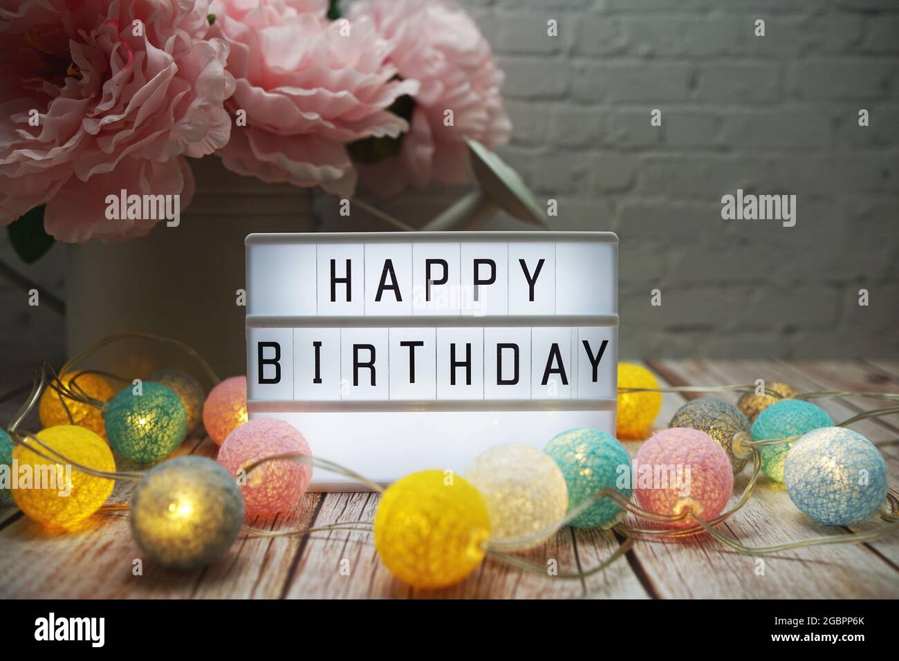Happy Birthday text on lightbox on wooden background Stock Photo - Alamy