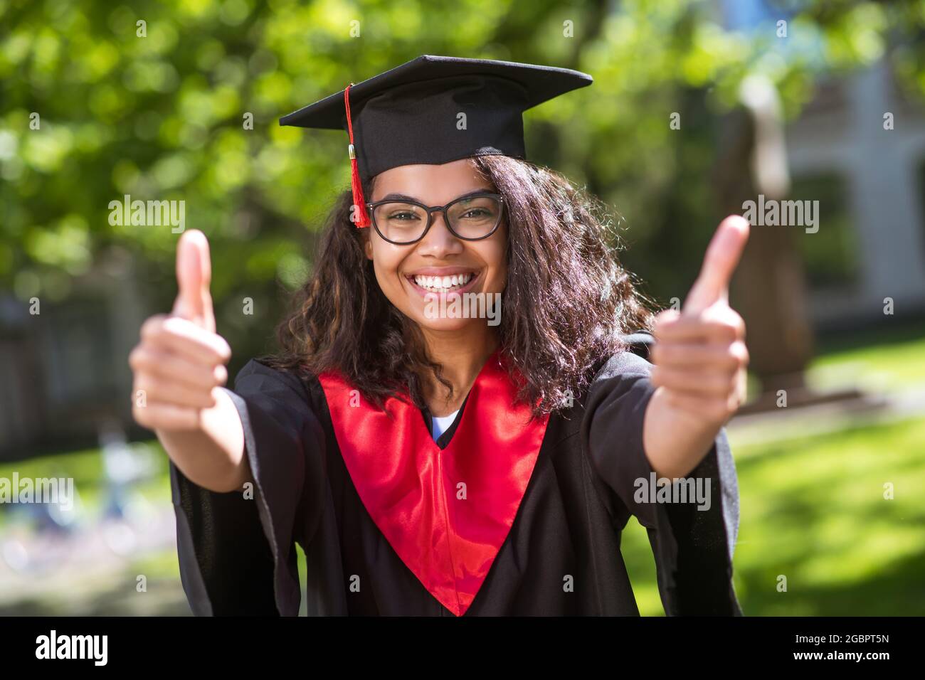 Pretty young girl in academic cap feeling happy about graduation Stock ...