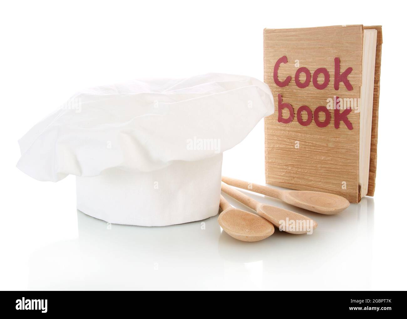 Chef's hat with spoons and cook book isolated on white Stock Photo - Alamy