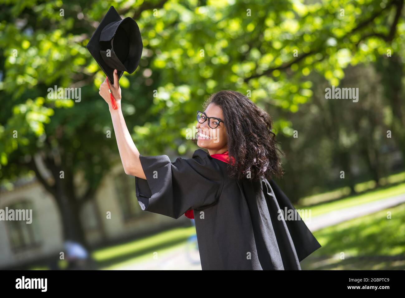 Dark-haired graduate feeling happy and excited about graduation Stock ...