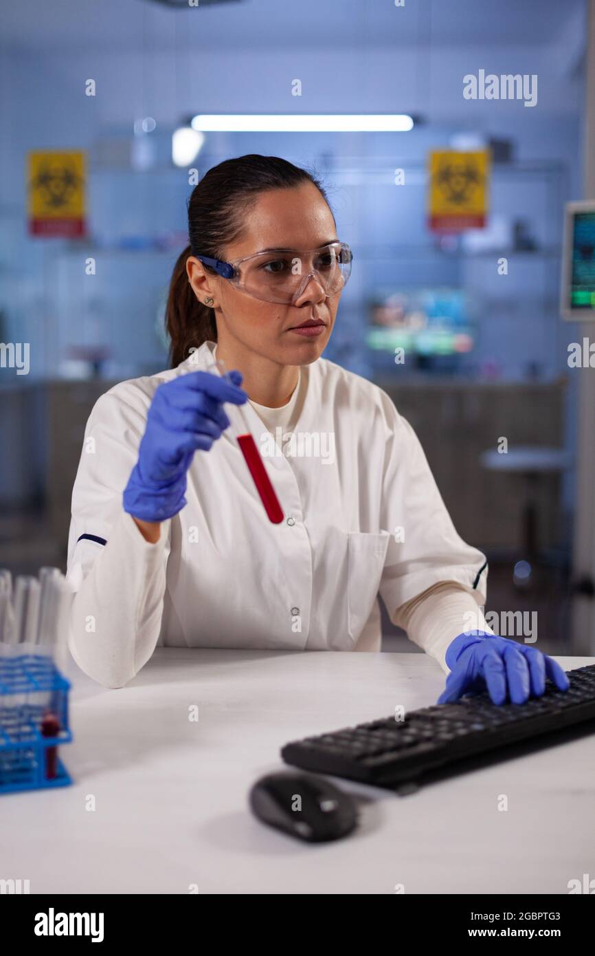 Biotechnology doctor in laboratory testing blood sample in tube for ...