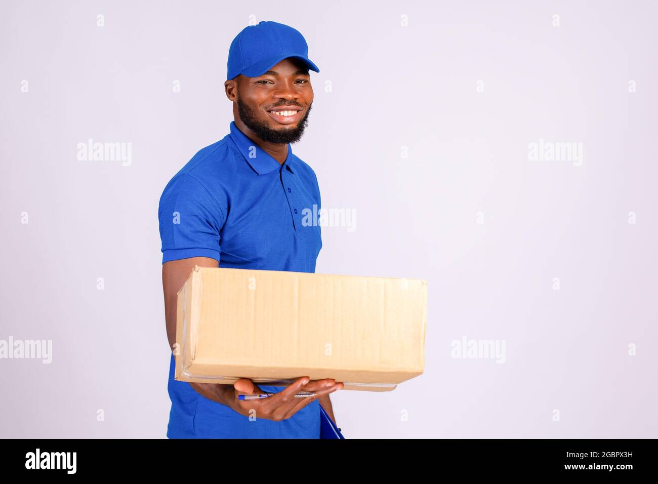 african delivery worker doing handing over gesture of a package to a ...