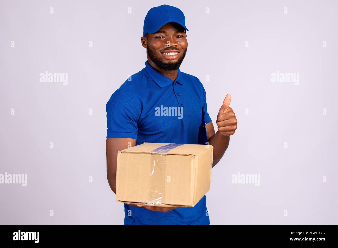 african delivery worker doing handing over gesture of a package to a ...