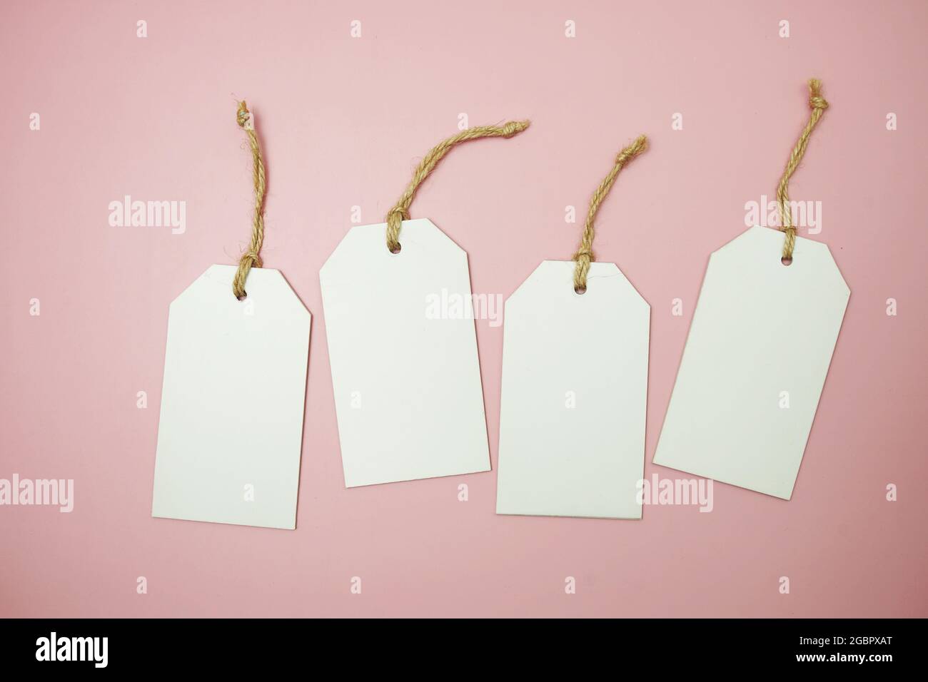 Flat lay White Blank Tag on pink background Stock Photo - Alamy