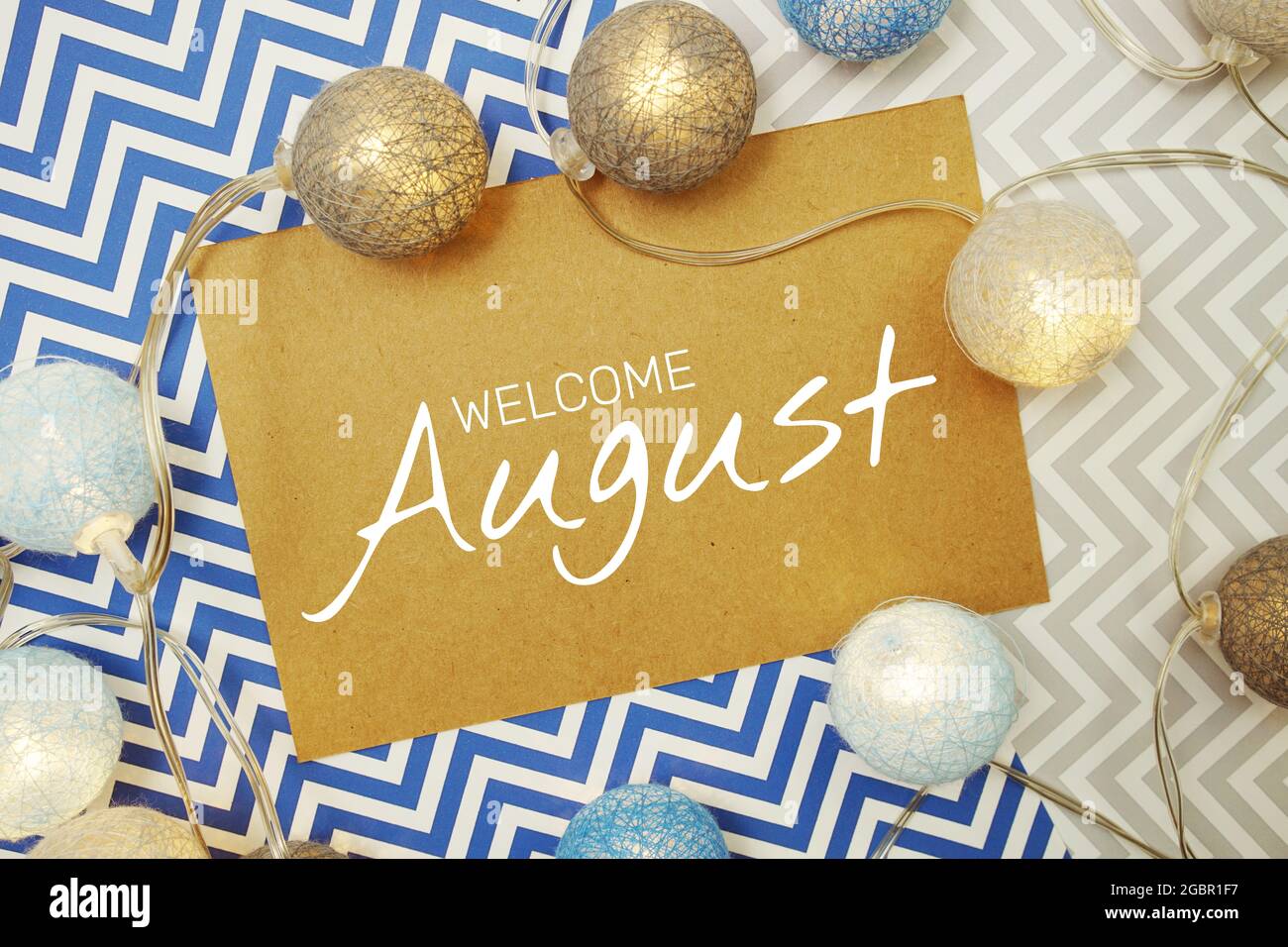 Welcome August typography text on paper card with LED cotton balls ...