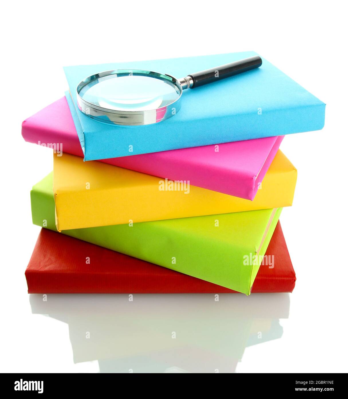color books with magnifying glass isolated on white Stock Photo - Alamy
