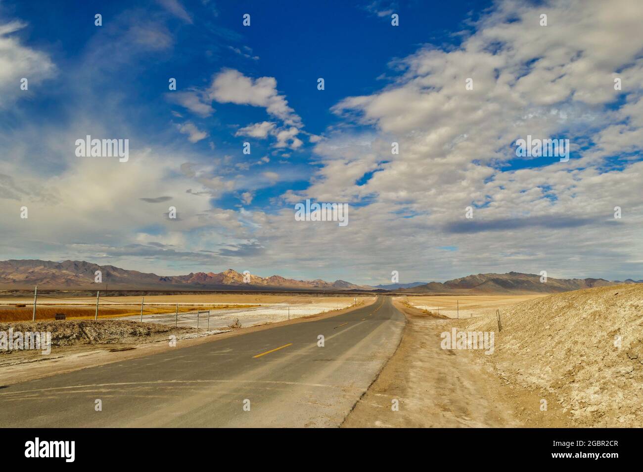 Lonely road through the desert and salt flats between Tecopa and the ...