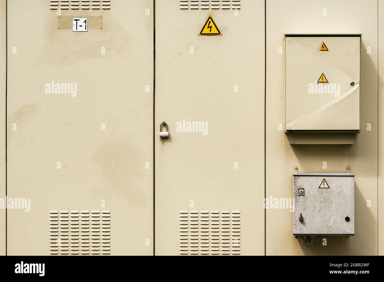 Electrical cabinet with warning signs and padlocks at a street Stock ...