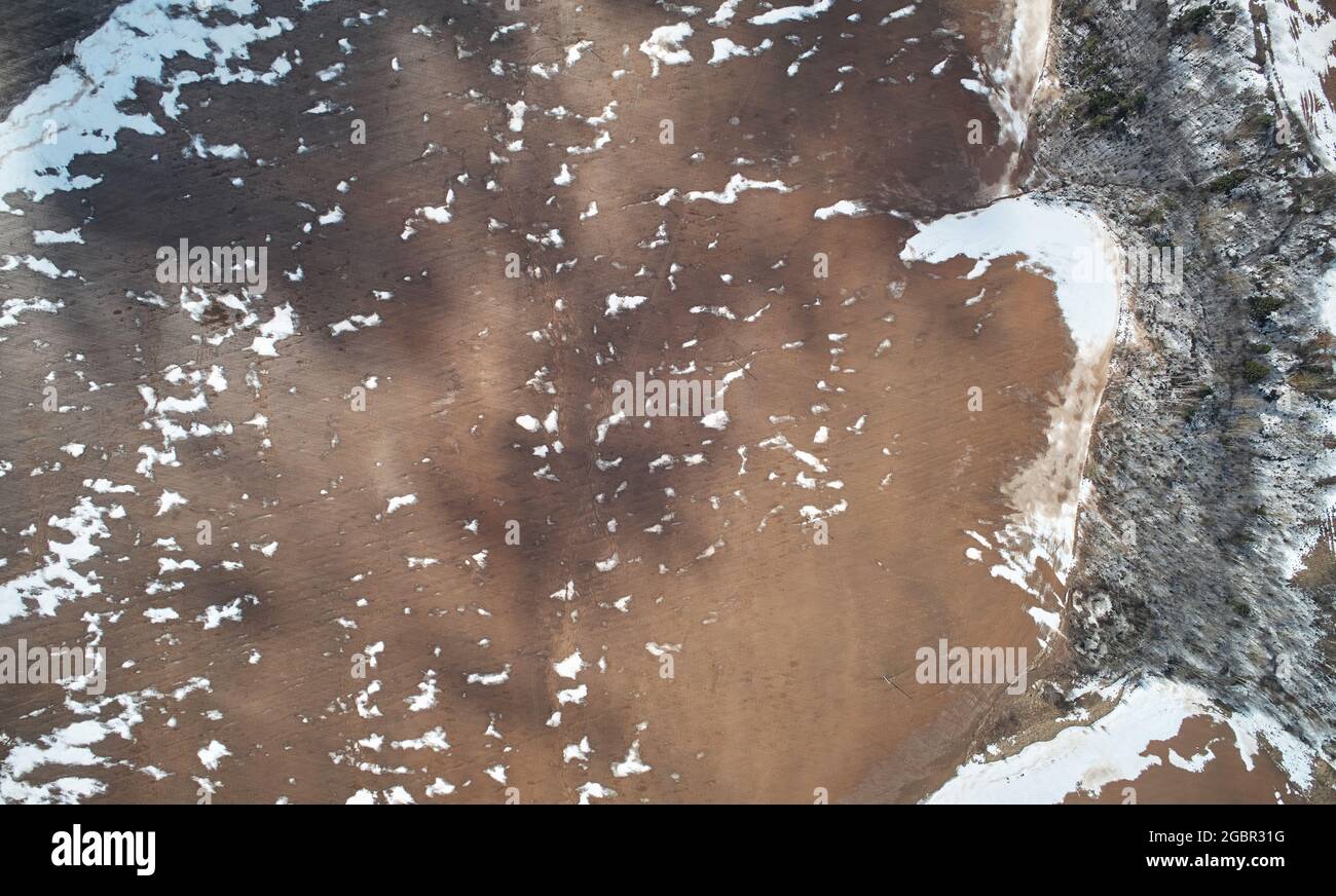 Land covered with snow spots above drone top view Stock Photo - Alamy