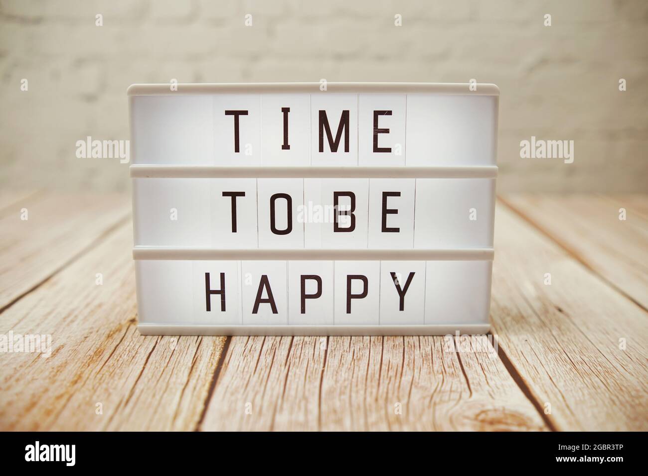Time To Be Happy word in light box on wooden background Stock Photo - Alamy