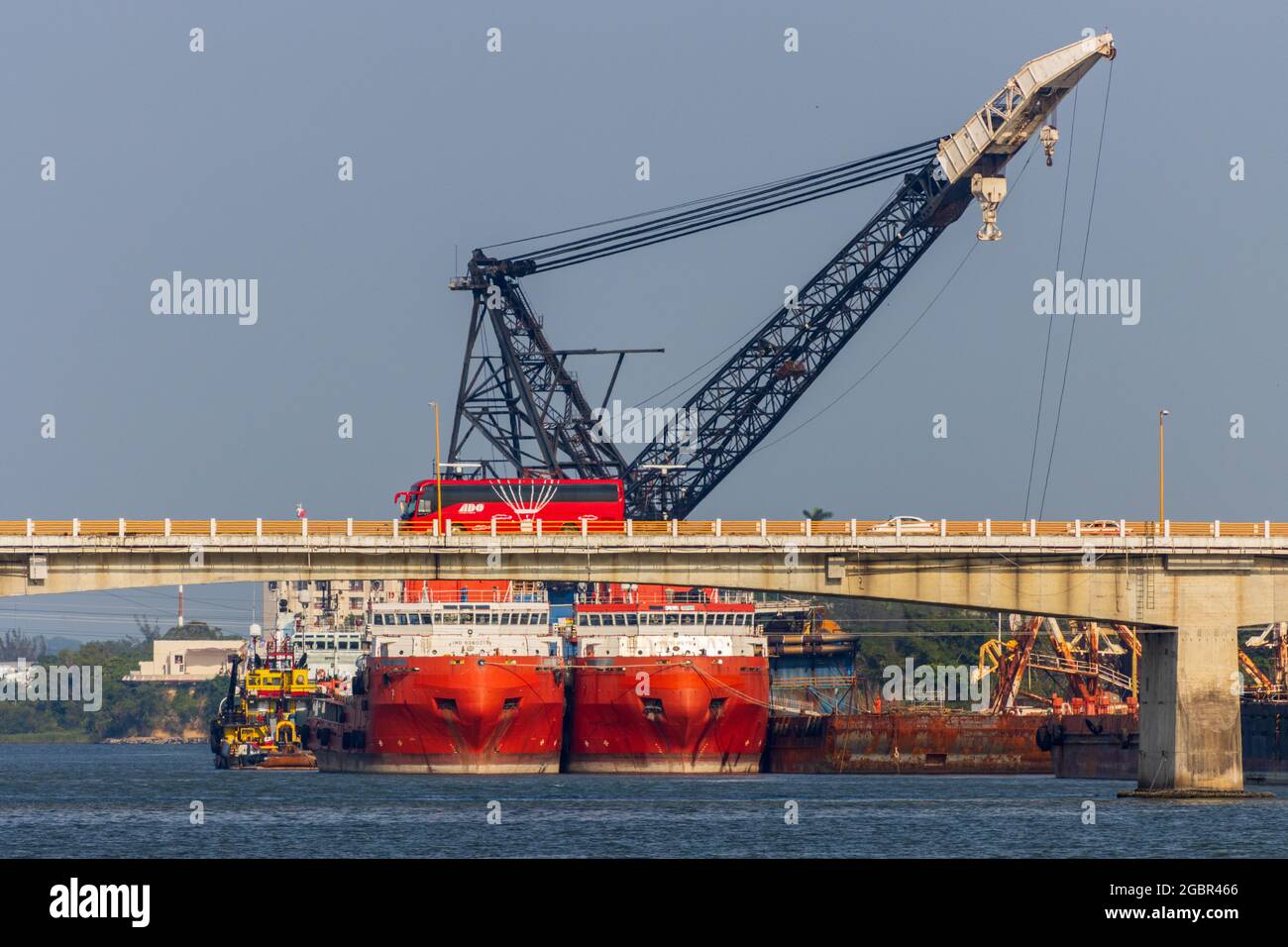 Industrial crane on a harbor next to a bridge Stock Photo - Alamy